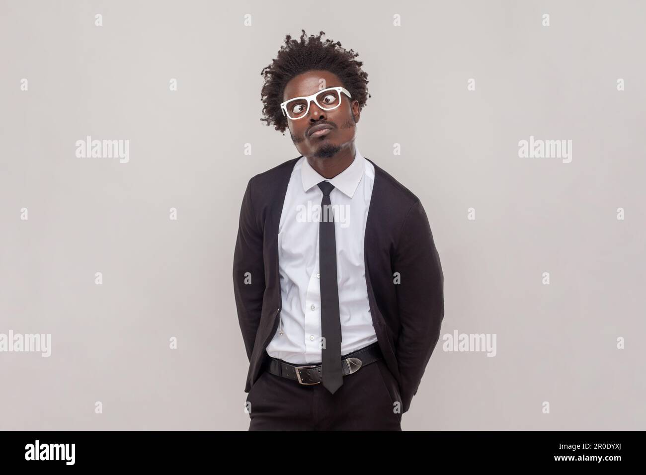 Portrait of funny comic man in glasses crosses eyes, pouts lips, makes ...