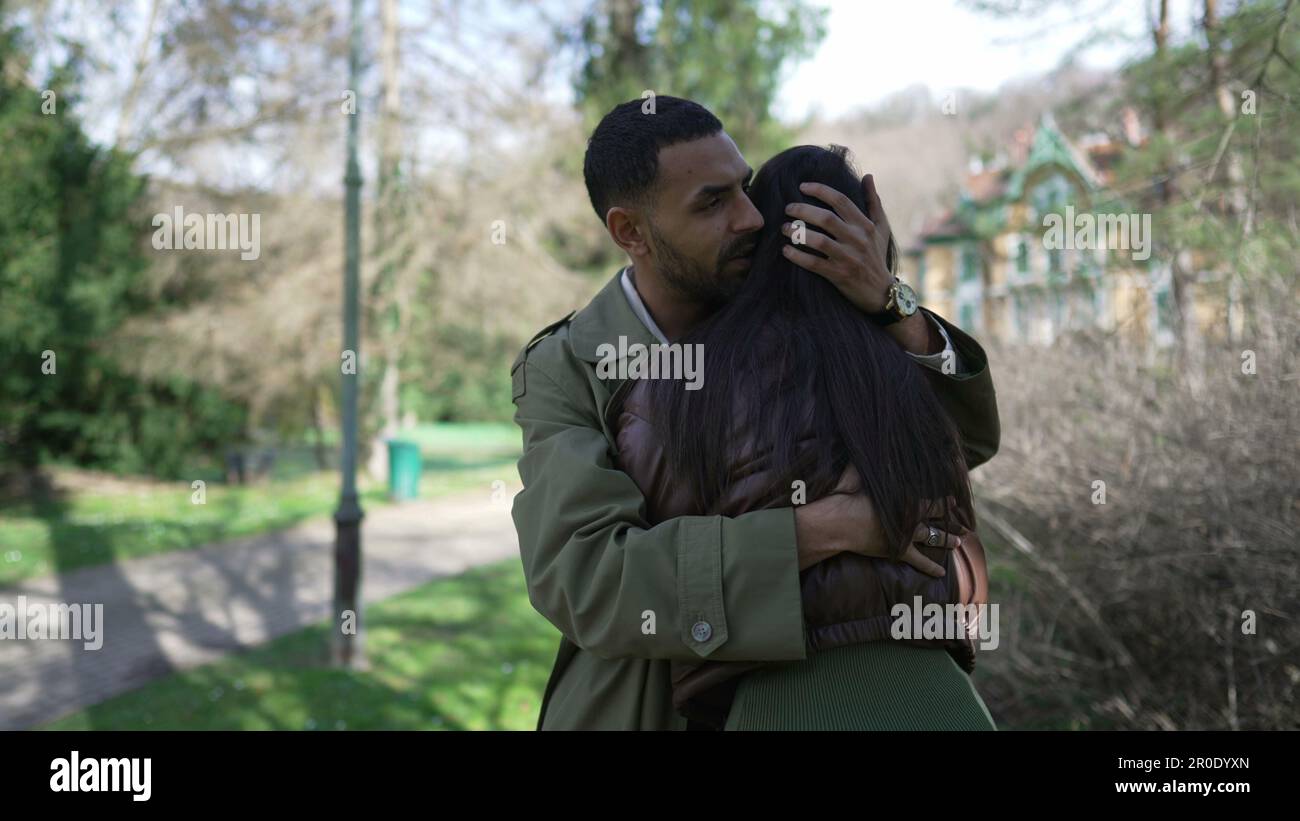 A MIddle Eastern boyfriend consoling sad depressed girlfriend standing ...