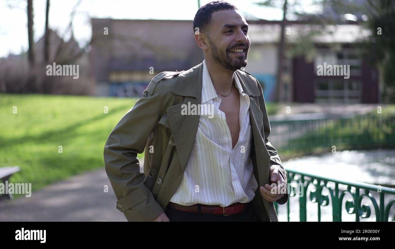 A Middle Eastern Man Exults in Triumph at a Sunny Park, Overflowing ...