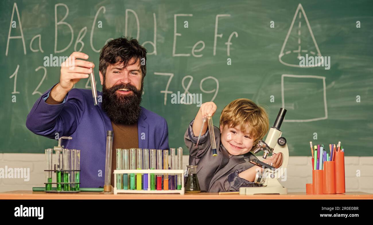 teacher man with little boy. School education. science camp. Chemistry ...
