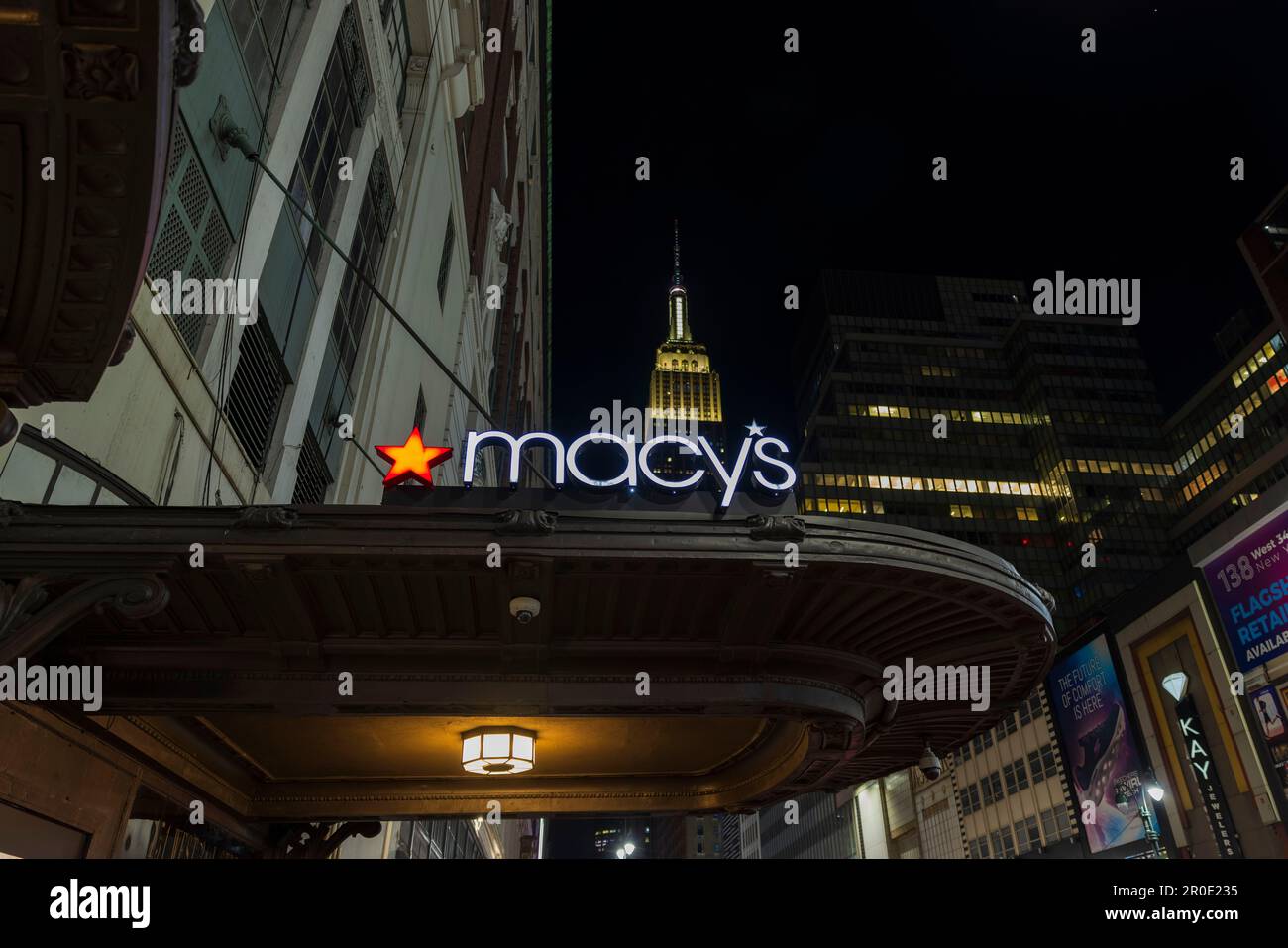 Night view of exterior of Macy's sign on store wall with Empire State ...
