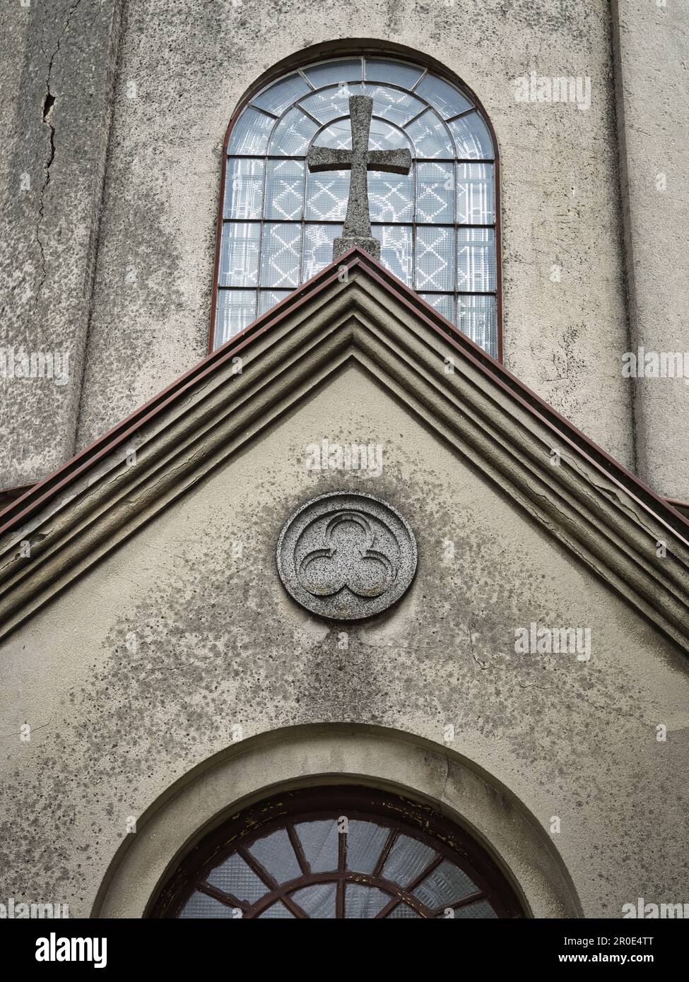 The symbol of the Holy Trinity on the facade of the church above the ...