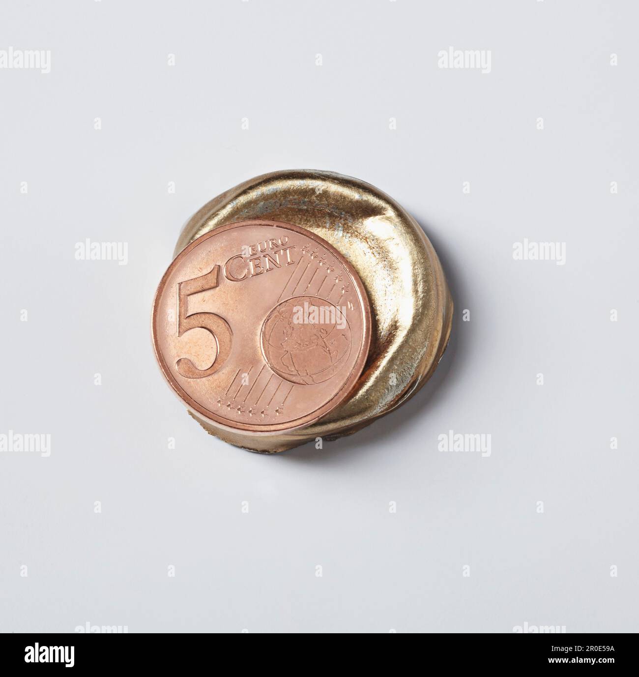 A symbolic image of a gourmet investment: a five Euro cent piece on a ...