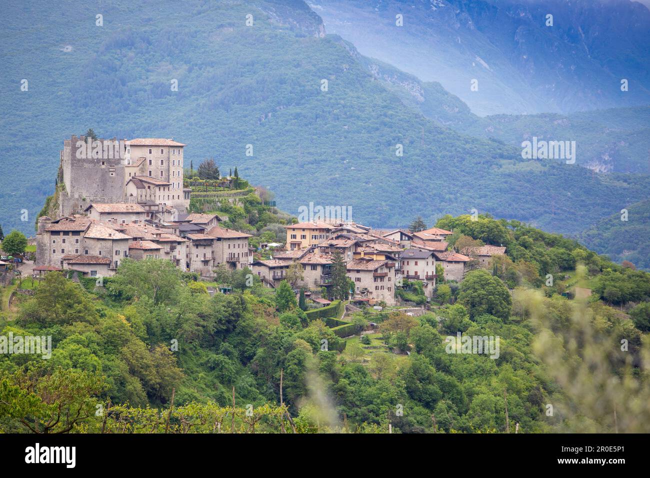 A view of the village of Tenno in the landscape of wooded Trentino ...