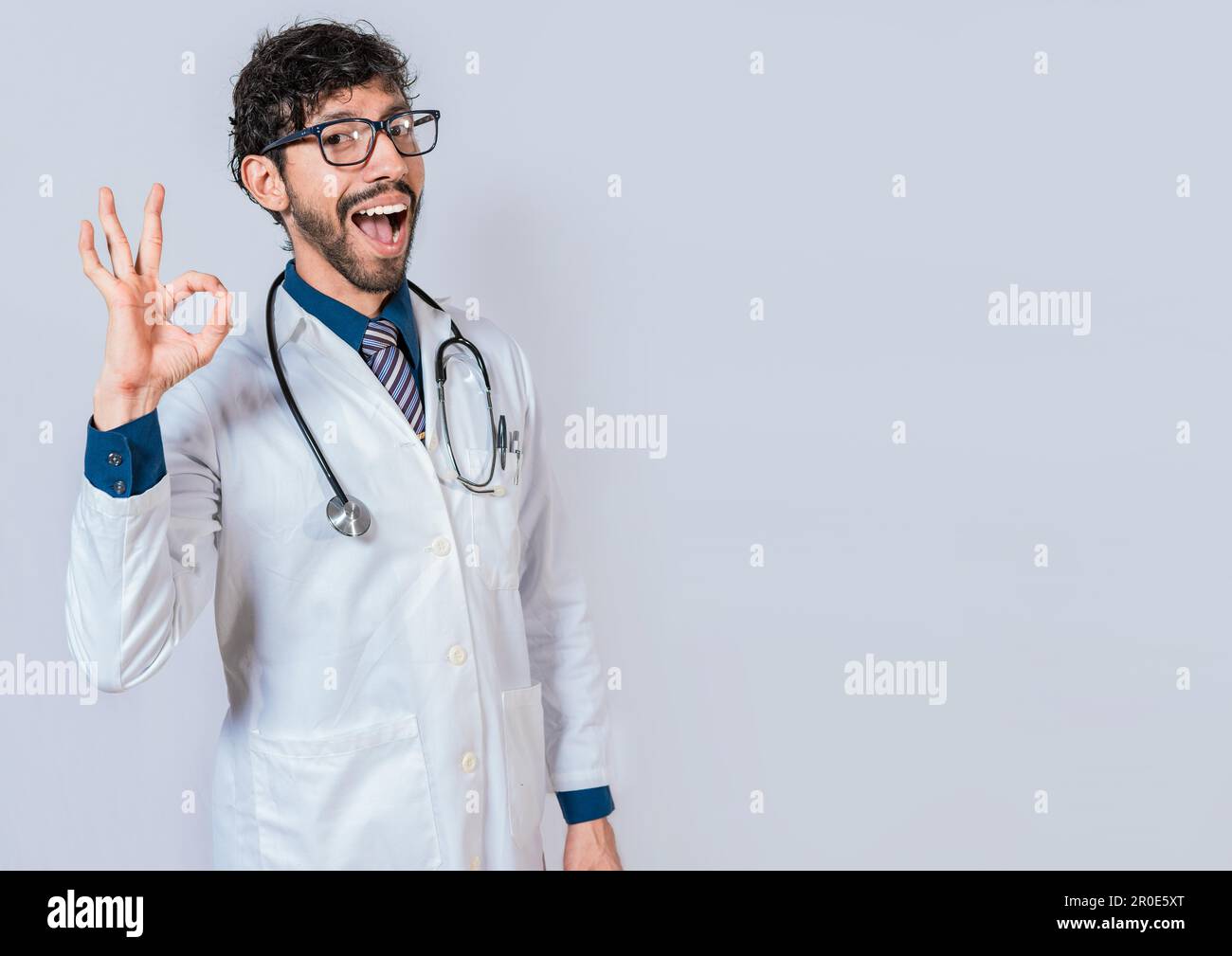 Latin doctor gesturing approval isolated. Handsome doctor approving and ...