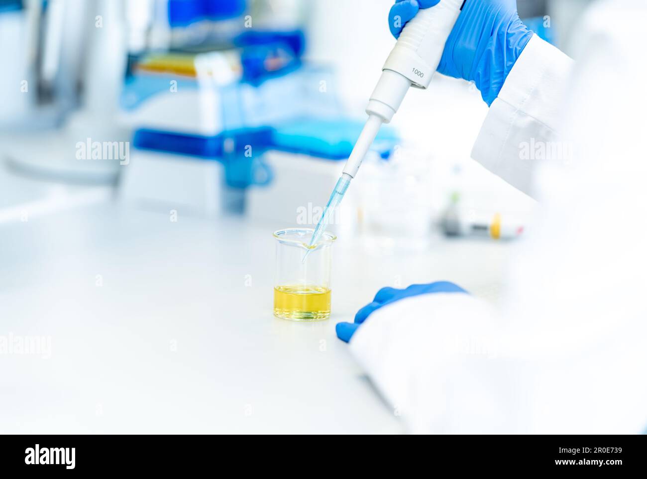 pipetting a chemical sample into research glass flasks Stock Photo - Alamy