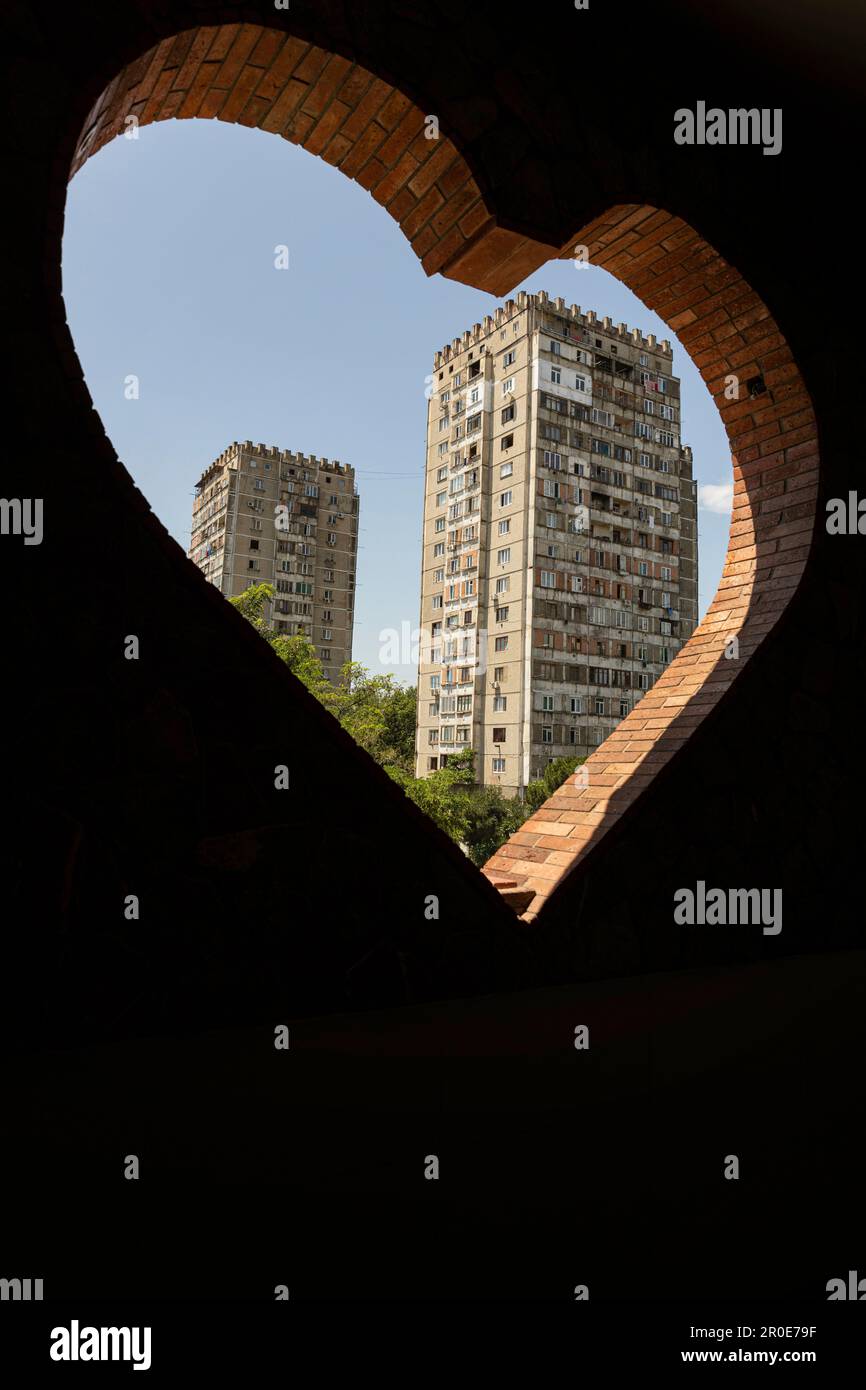 A view through a heart-shaped peephole of a tower block, Soviet ...