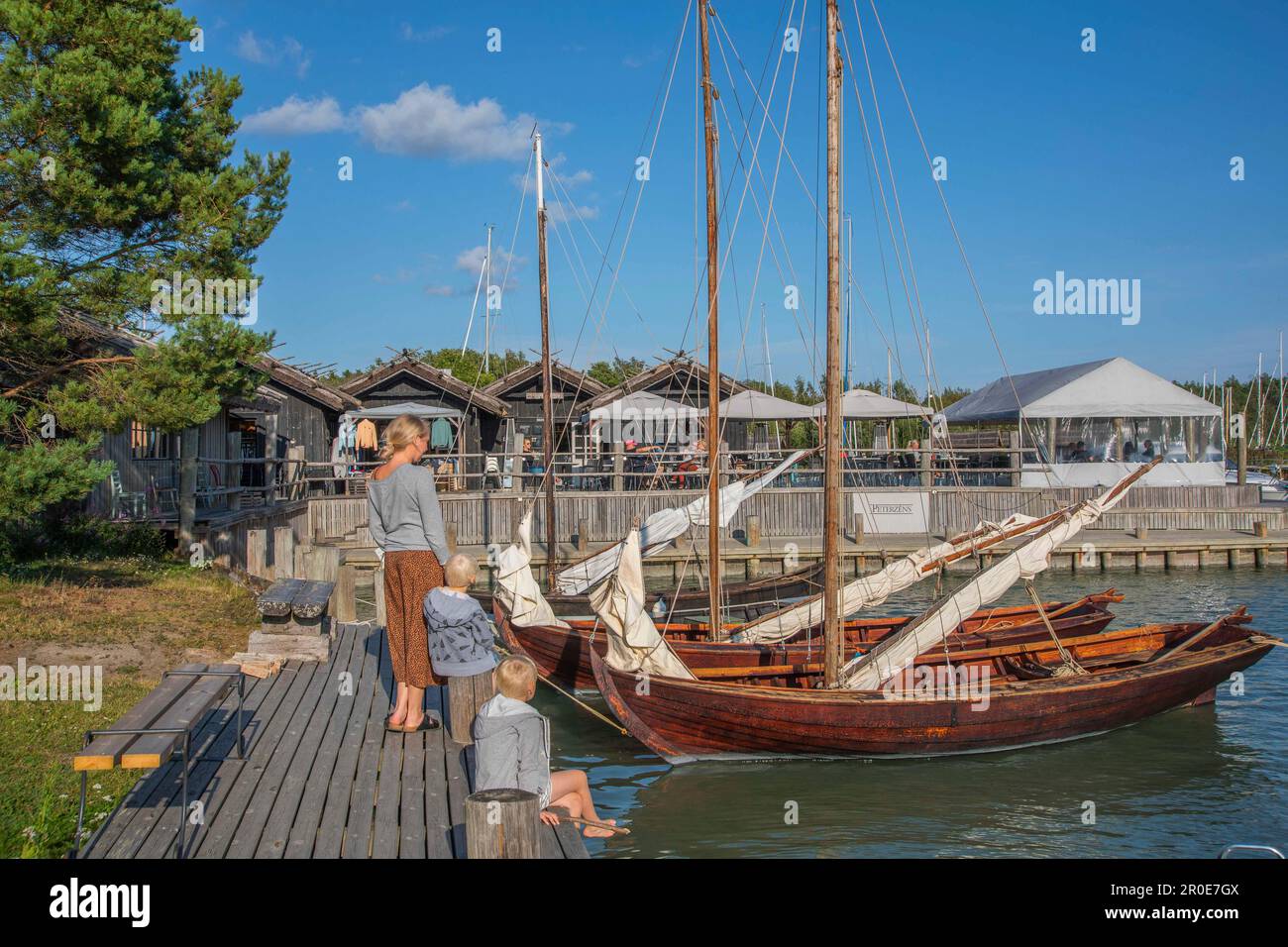Sailing boats and families at the harbour in Kustavi, west coast of ...
