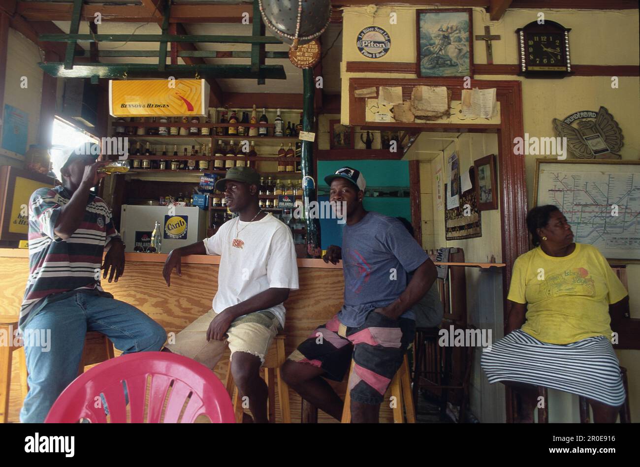 Three native men sitting at a bar, St. Lucia, Caribbean Stock Photo - Alamy