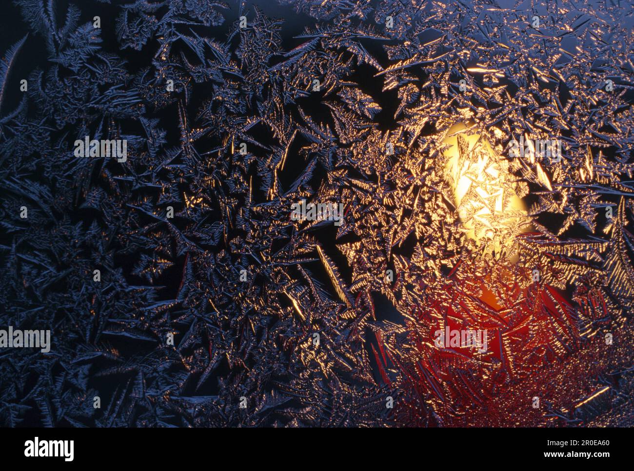 Candle behind ice-covered window Stock Photo - Alamy