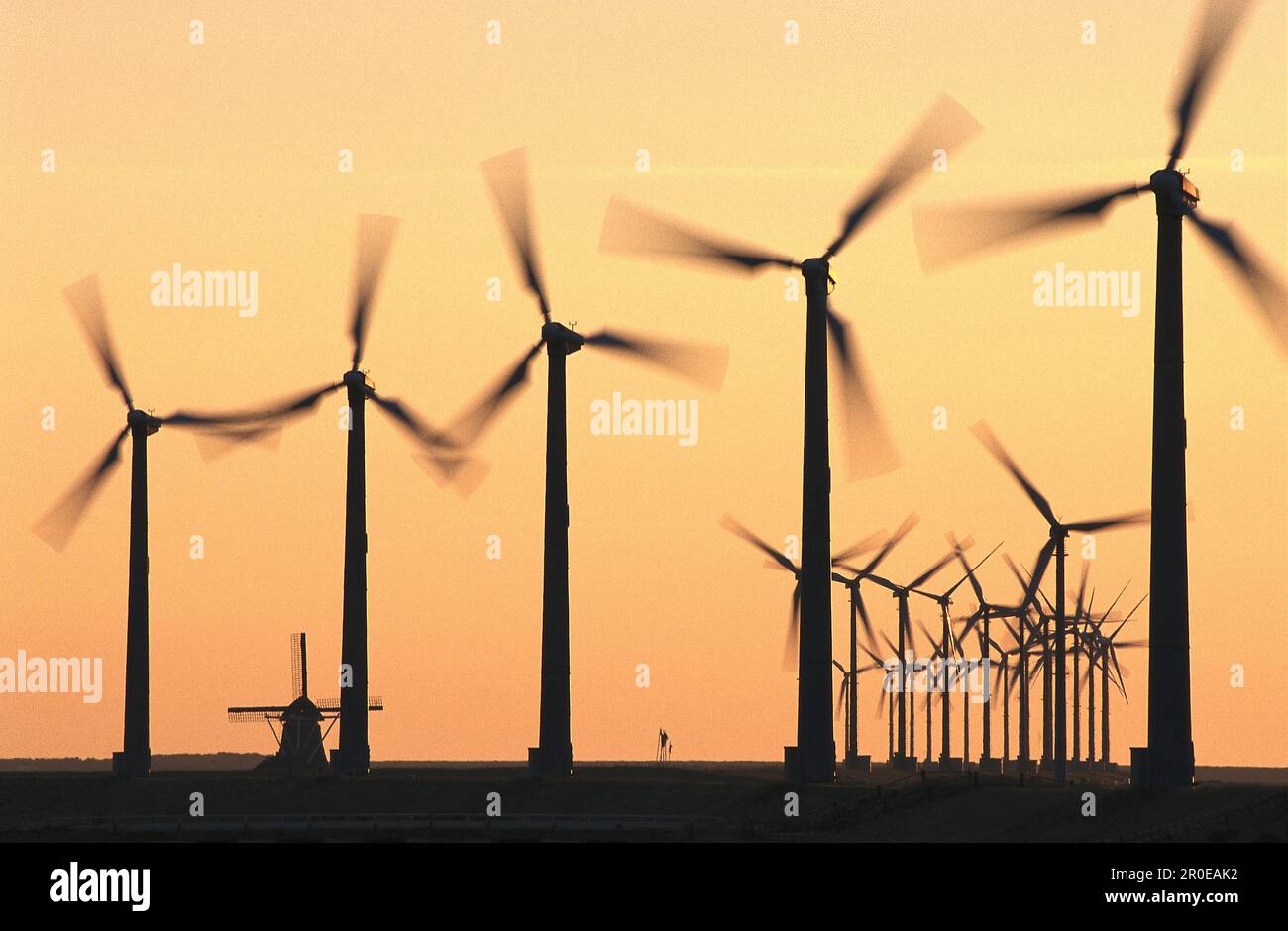 Modern wind farm with old windmill Stock Photo - Alamy