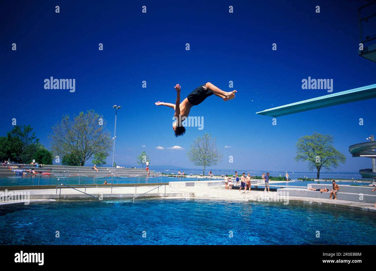 Boy jumping into swimming pool, Lake Constance, Arbon, Switzerland ...