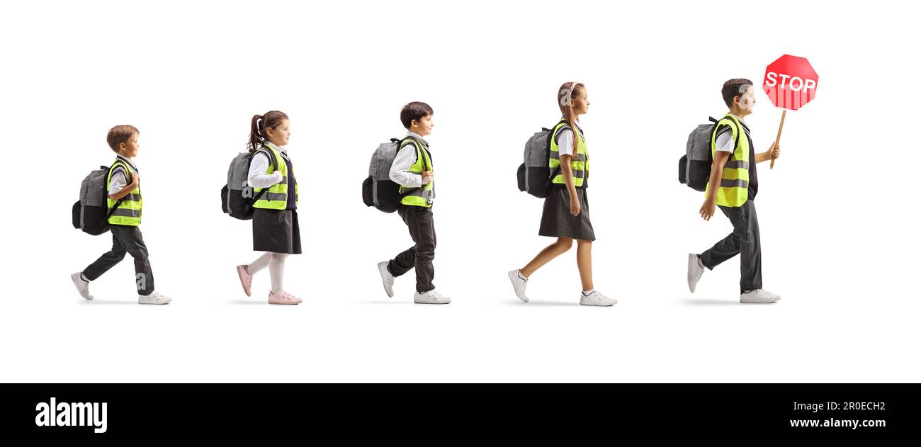 Children with safety vests holding a stop sign and walking in a line ...