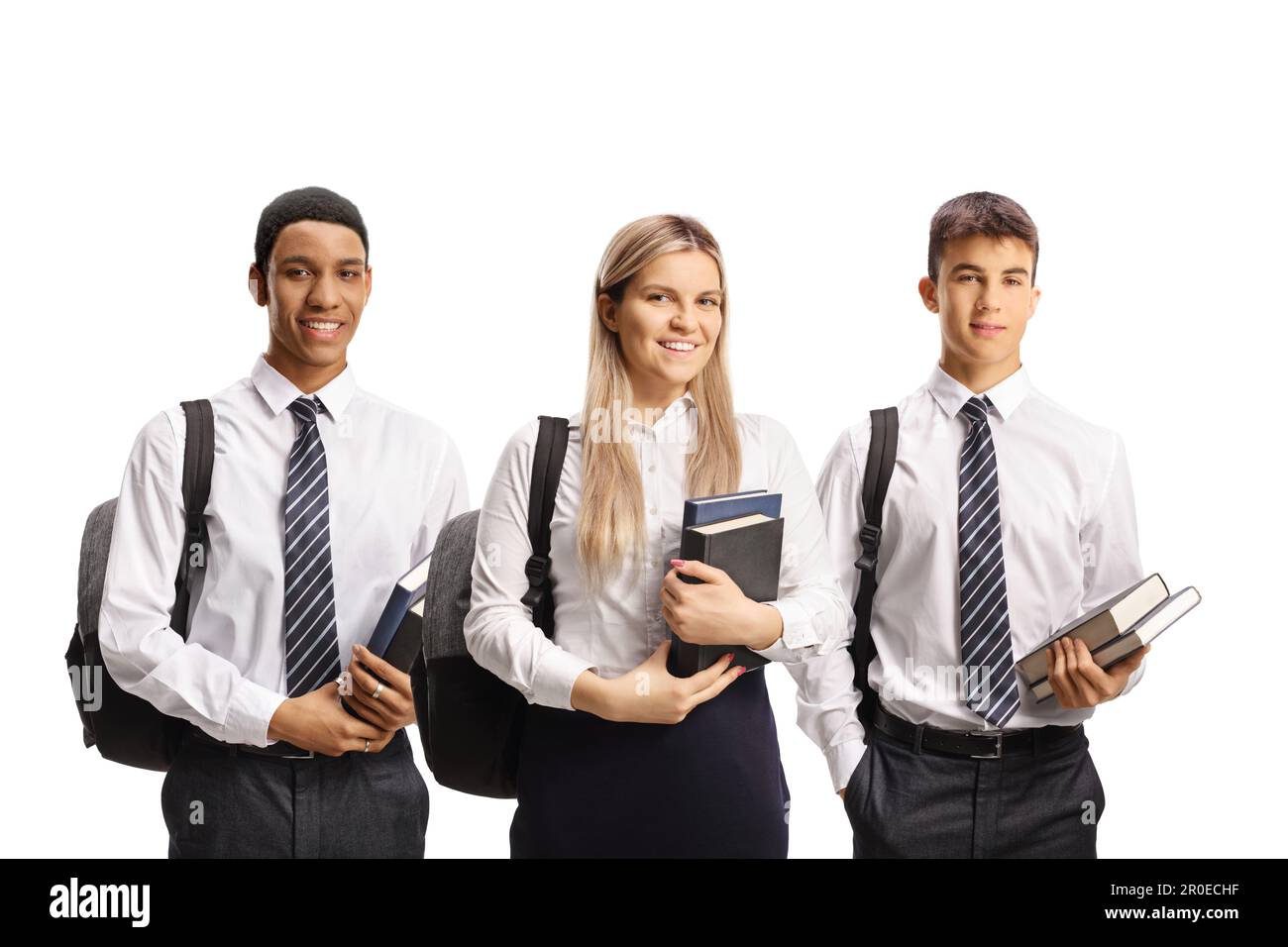 Male and female students in school uniforms holding books isolated on ...