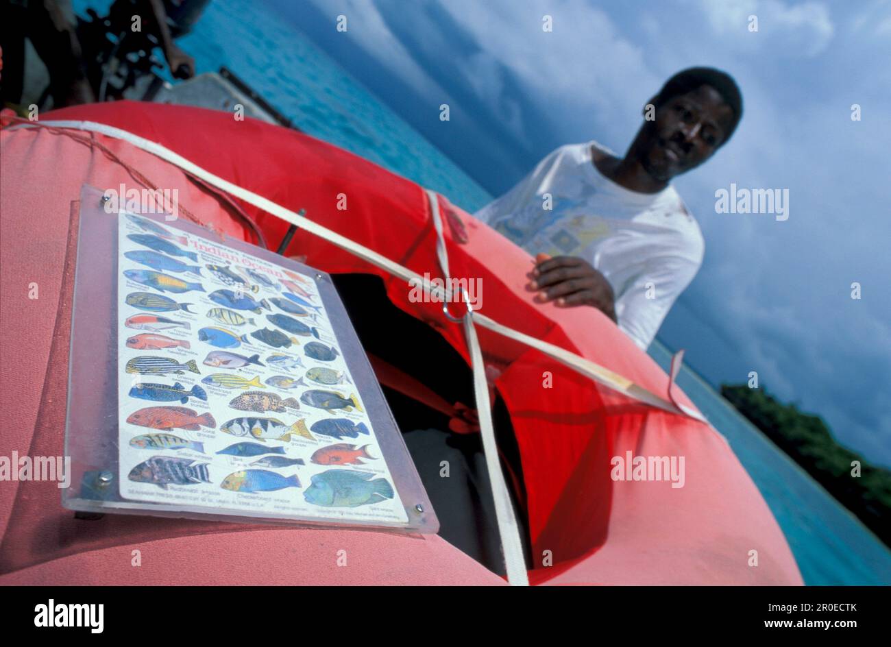 African man with life belt and information board on a boat, Chumbe ...