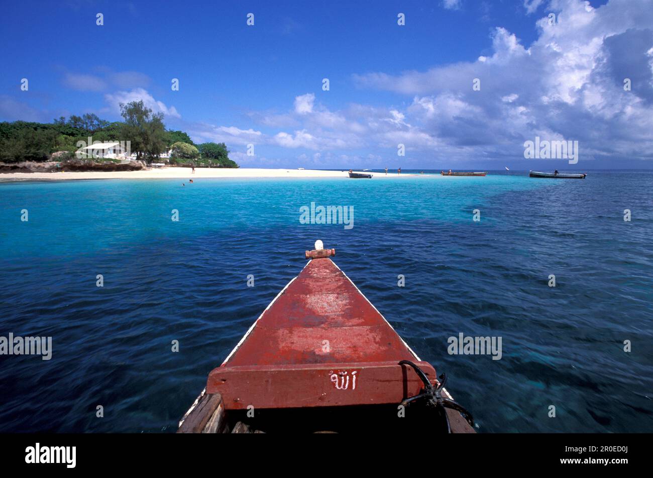 Wooden boat off the beach of Prison Island under blue sky, Zanzibar ...