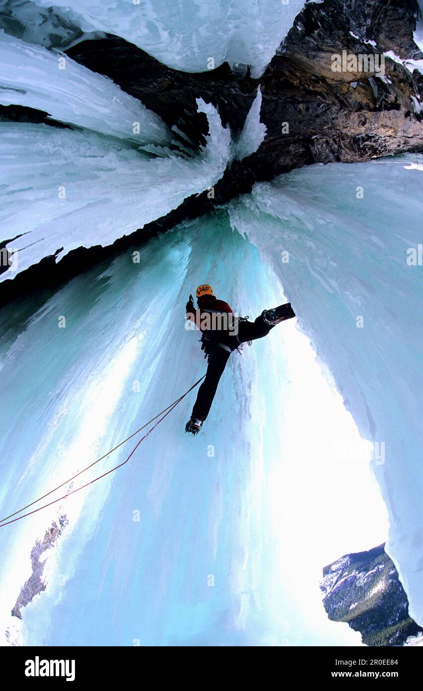 Man climbing in an ice cave, Golden Area, Banff National Park, Canada ...