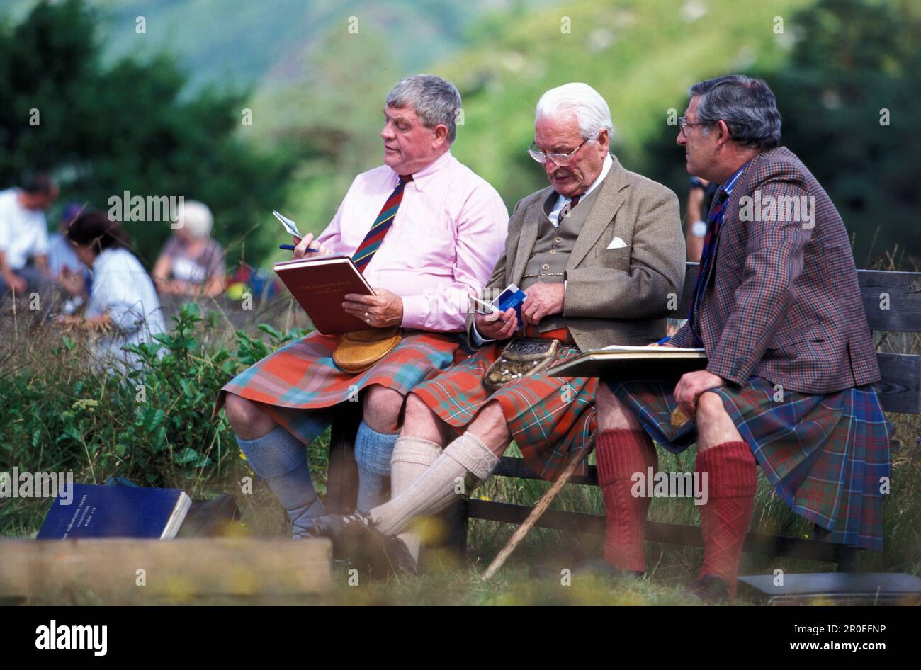 Men in kilts on a bench, judges at Glenfinnan Highland Games ...