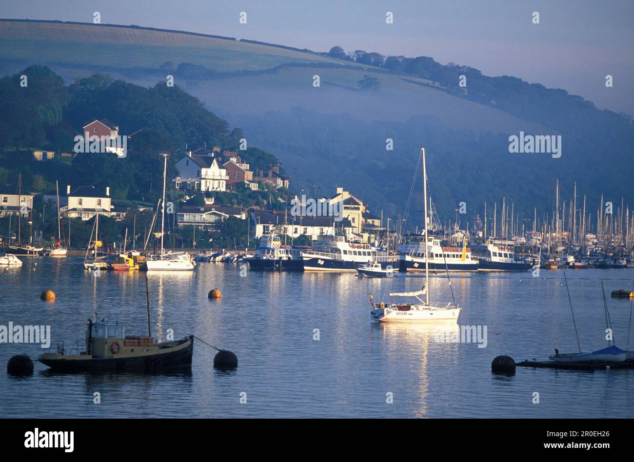 Boats at harbour and sailing boat in the sunlight, Dartmouth, Devon ...