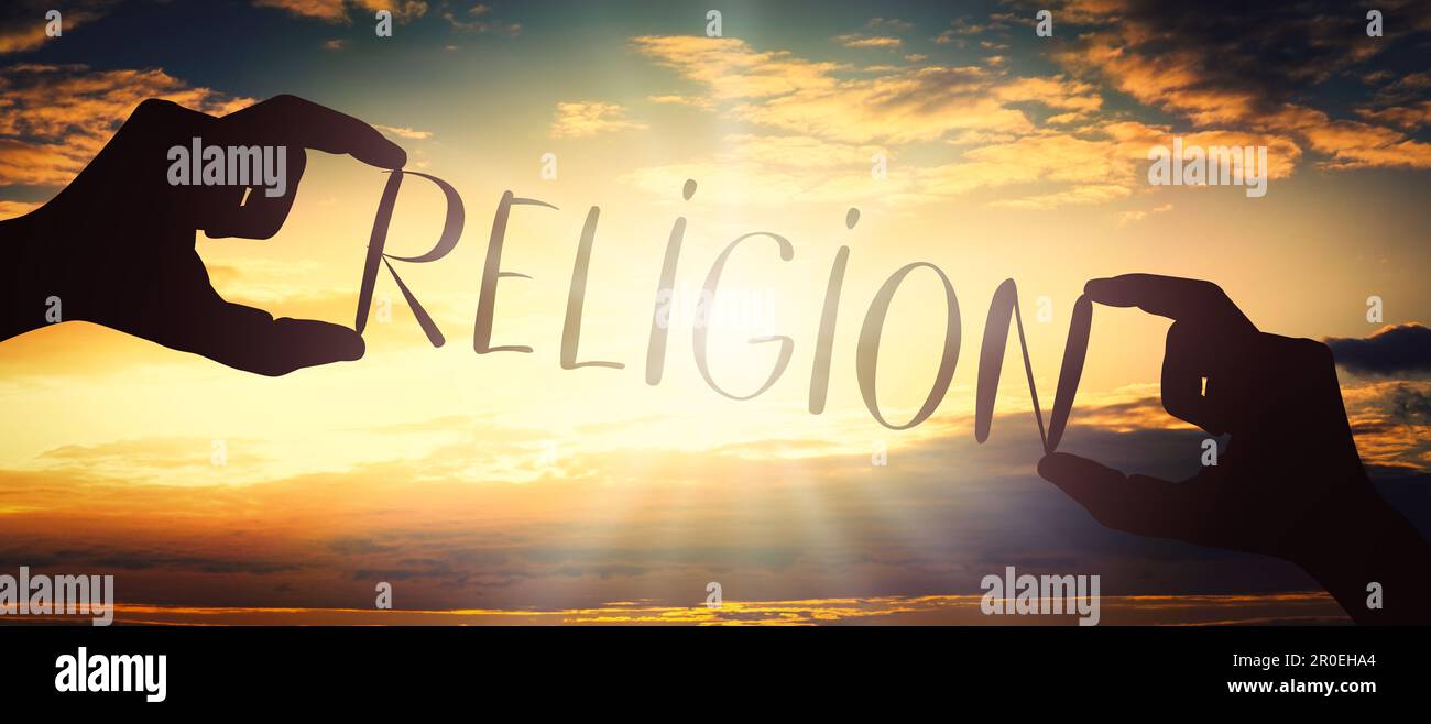Religion - human hands holding black silhouette word Stock Photo - Alamy
