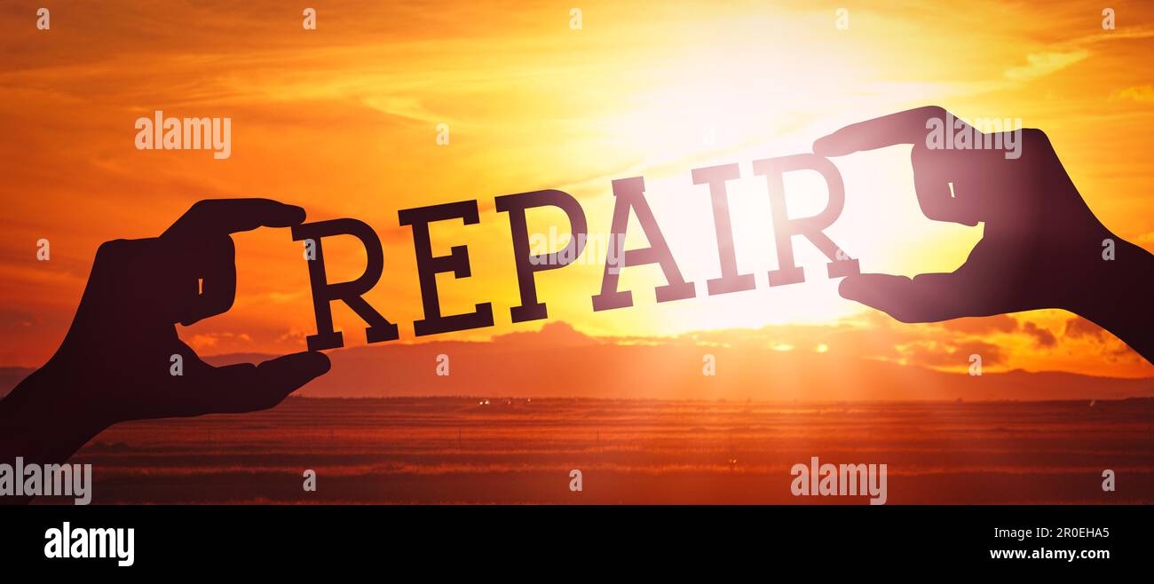 Repair - human hands holding black silhouette word Stock Photo - Alamy