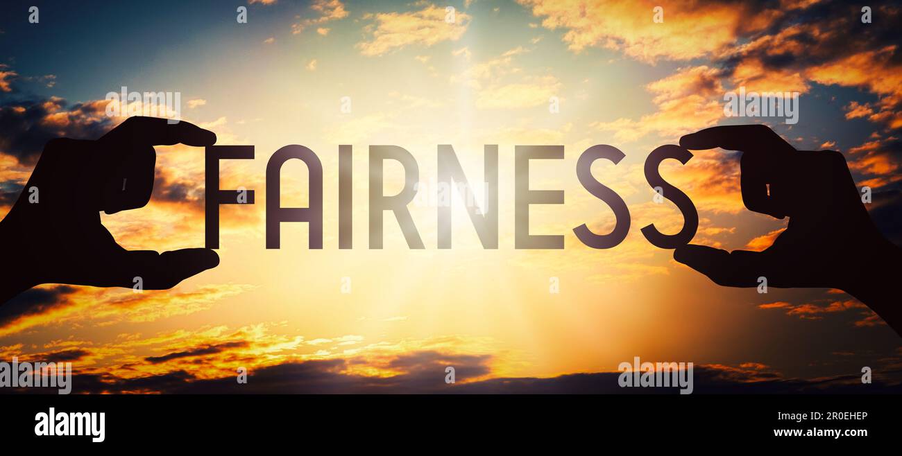 Fairness - human hands holding black silhouette word Stock Photo - Alamy