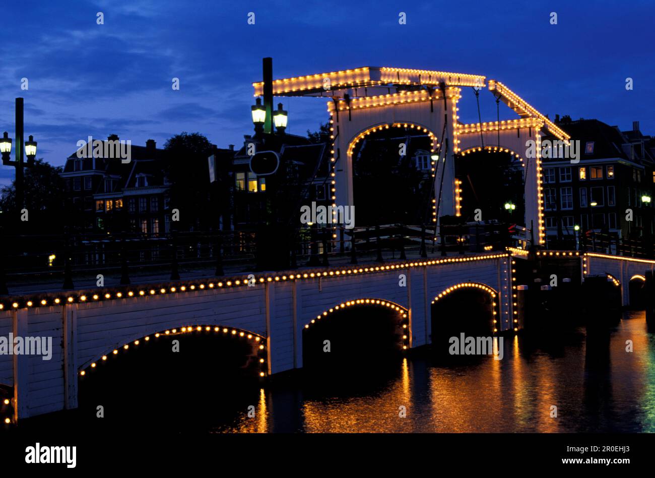 The illuminated Magere Brug bridge in the evening, Amsterdam ...