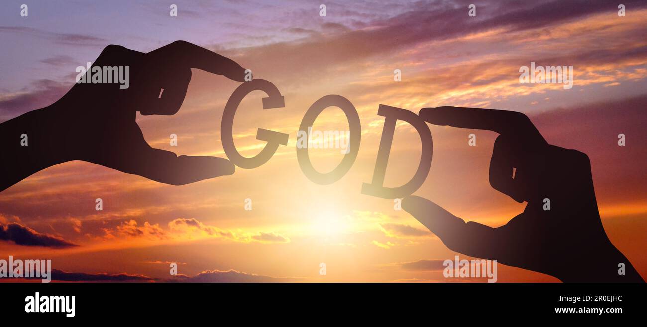 God - human hands holding black silhouette word Stock Photo - Alamy
