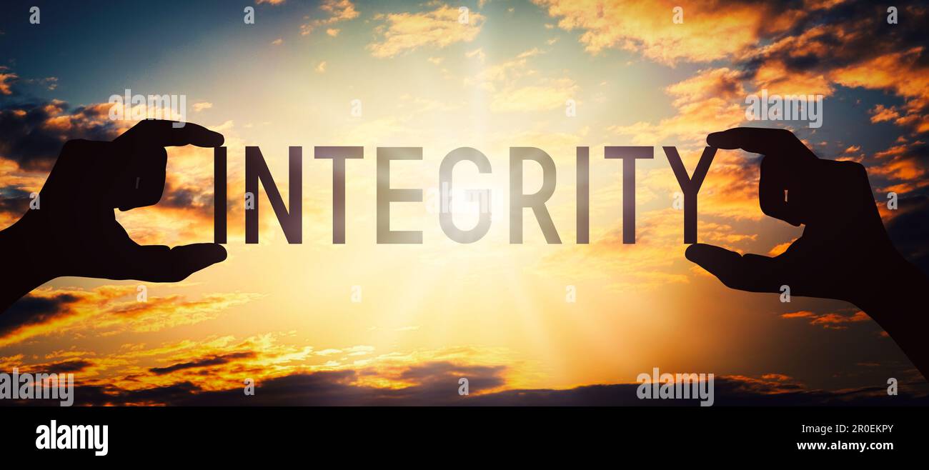 Integrity - human hands holding black silhouette word Stock Photo - Alamy