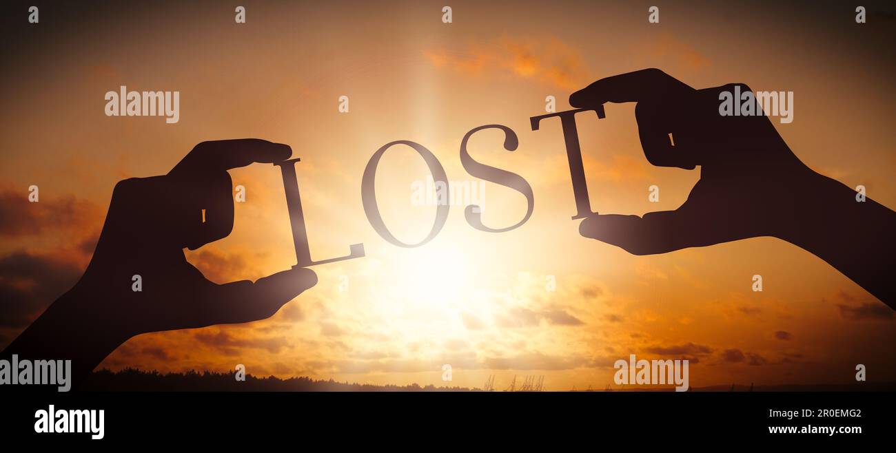 Lost - human hands holding black silhouette word Stock Photo - Alamy