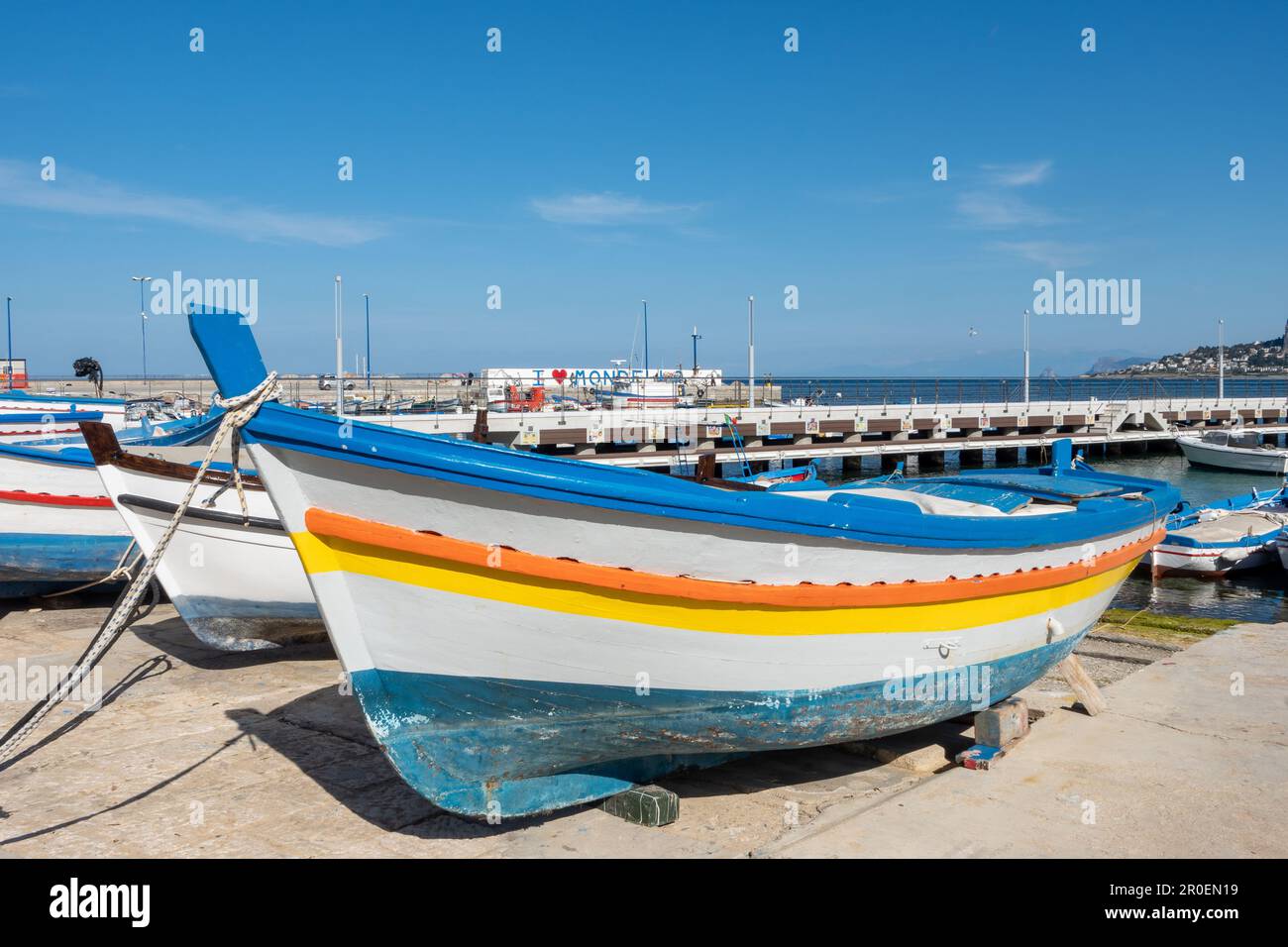 Traditional colorful fishing boats moored in the small port of Southern ...