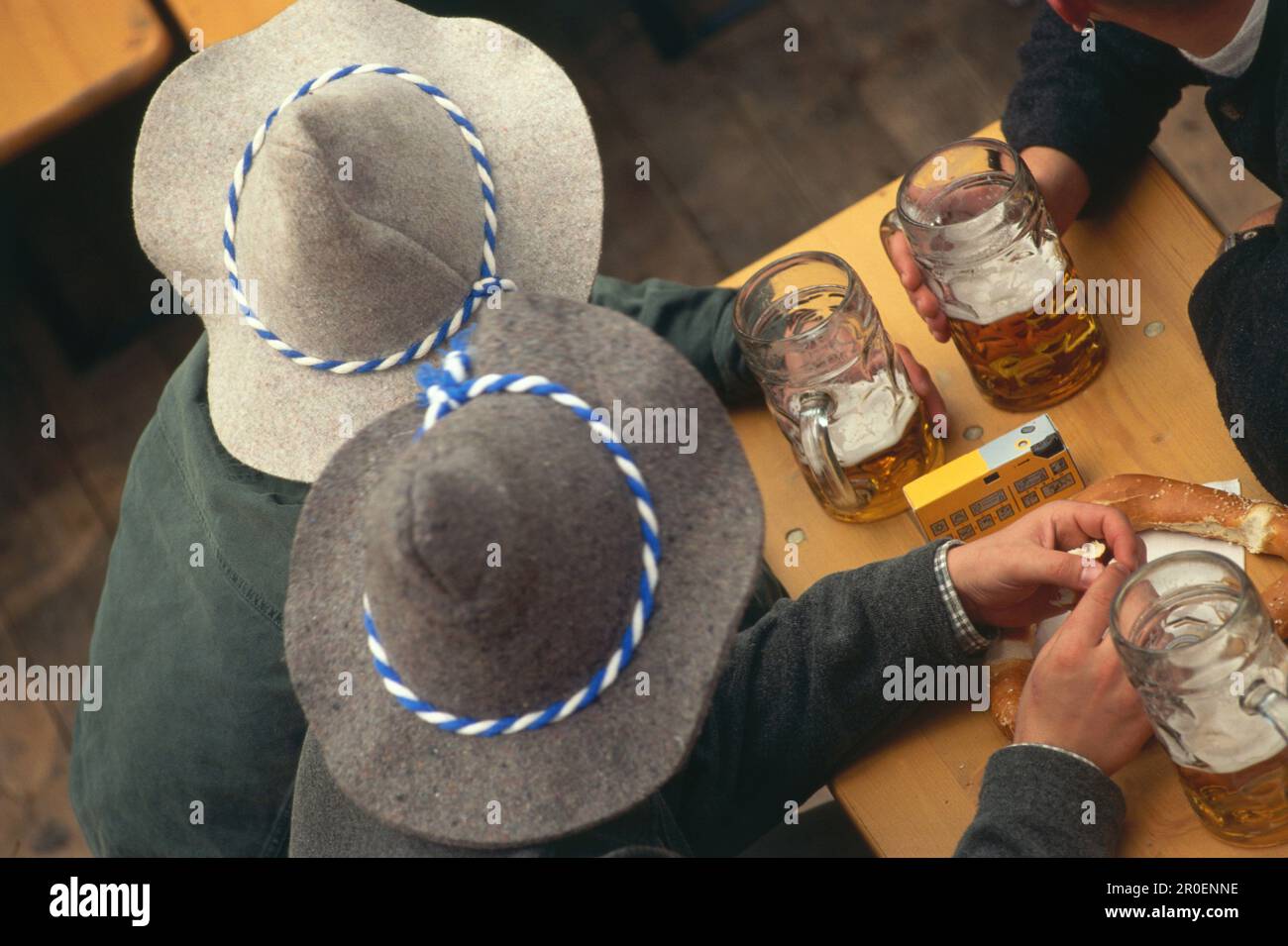 Two Men sitting on ale-bench with beer, Oktoberfest, Munich Stock Photo ...