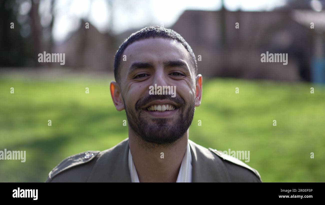Portrait of a happy Middle Eastern young man walking forward toward ...