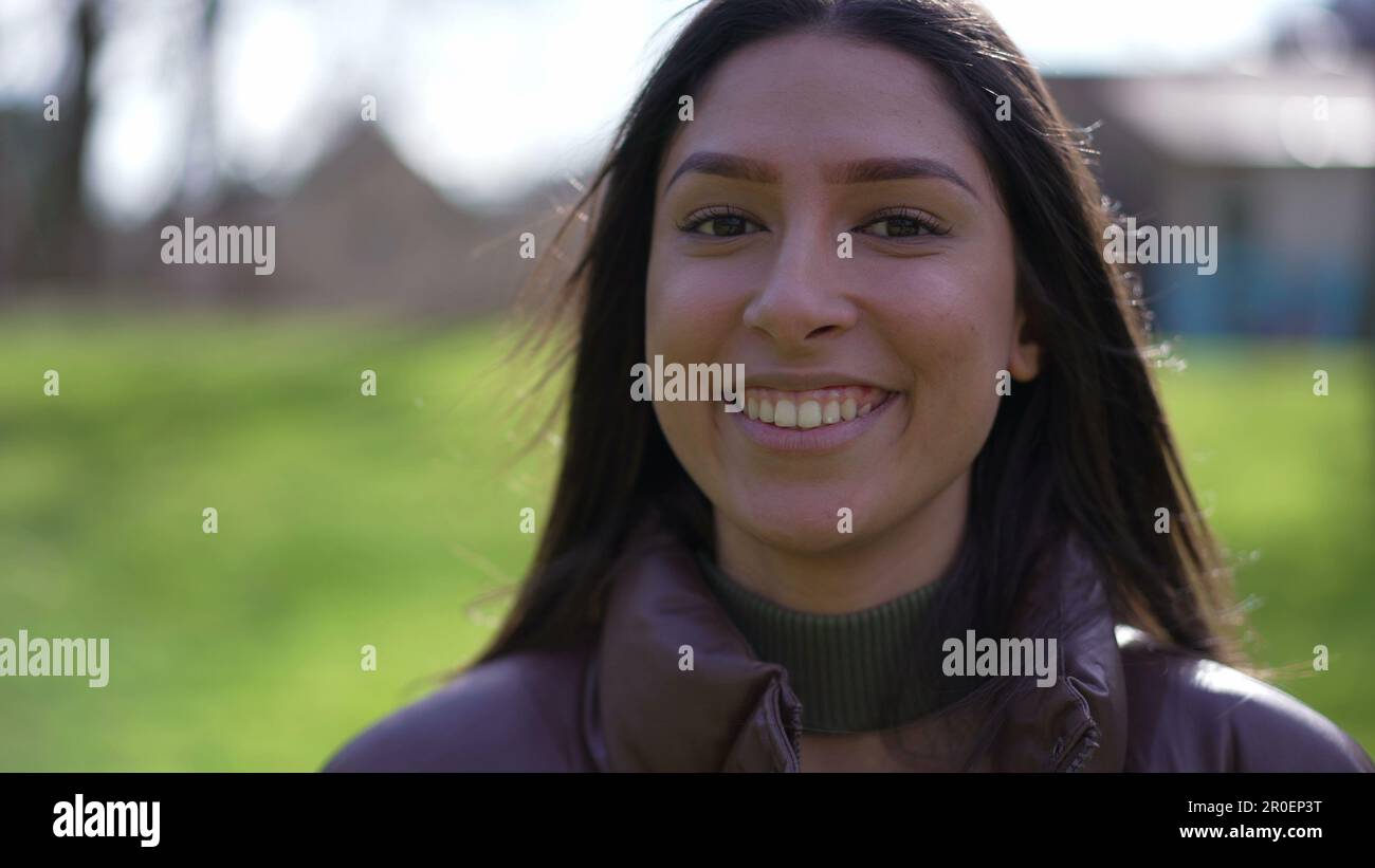 Portrait of a happy young Middle Eastern woman closeup face walking ...