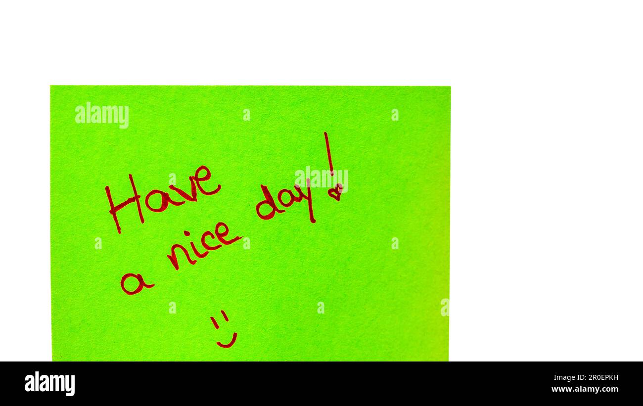 Havce a nice day handwriting text close up isolated on green paper with ...