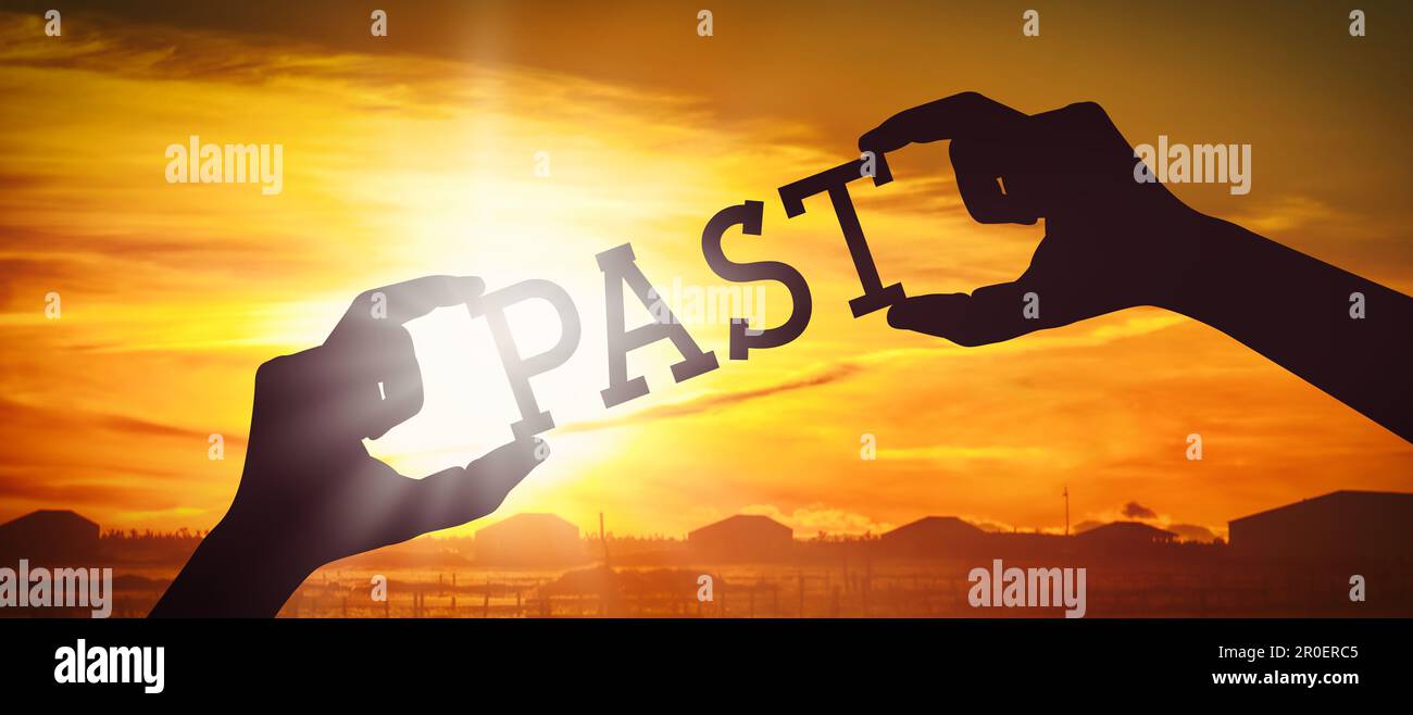 Past - human hands holding black silhouette word Stock Photo - Alamy