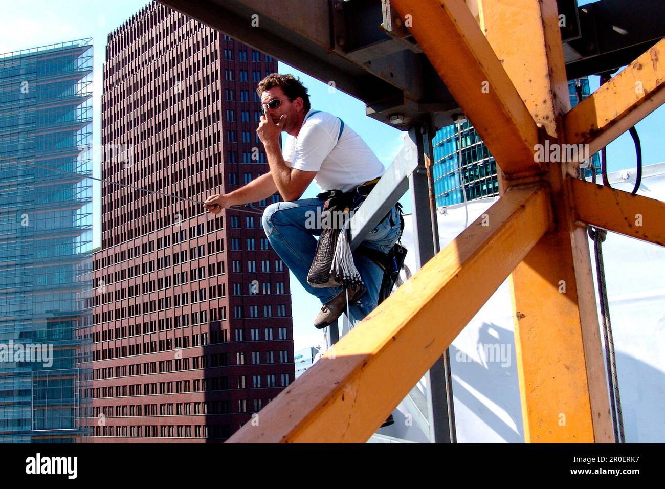Climber between crane and high rise buildings, Berlin, Germany, Europe ...