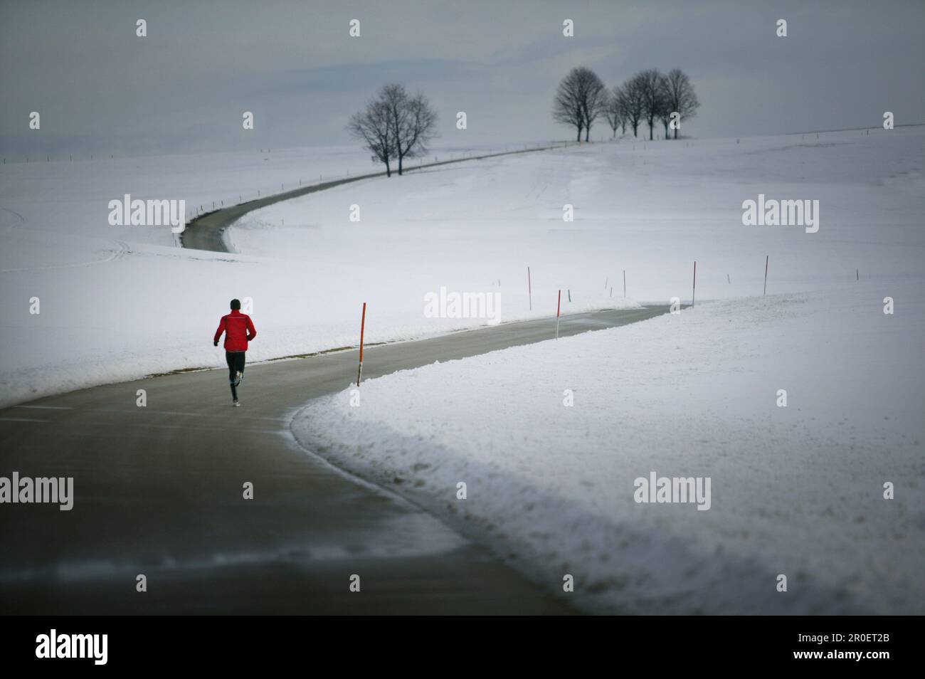 Young man running on country road Stock Photo - Alamy