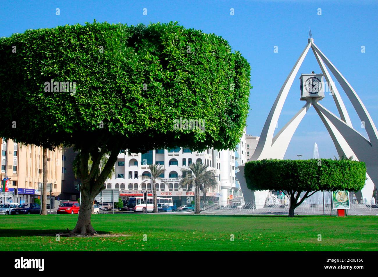 Trees and clock tower in the sunlight, Dubai, UAE, United Arab Emirates ...