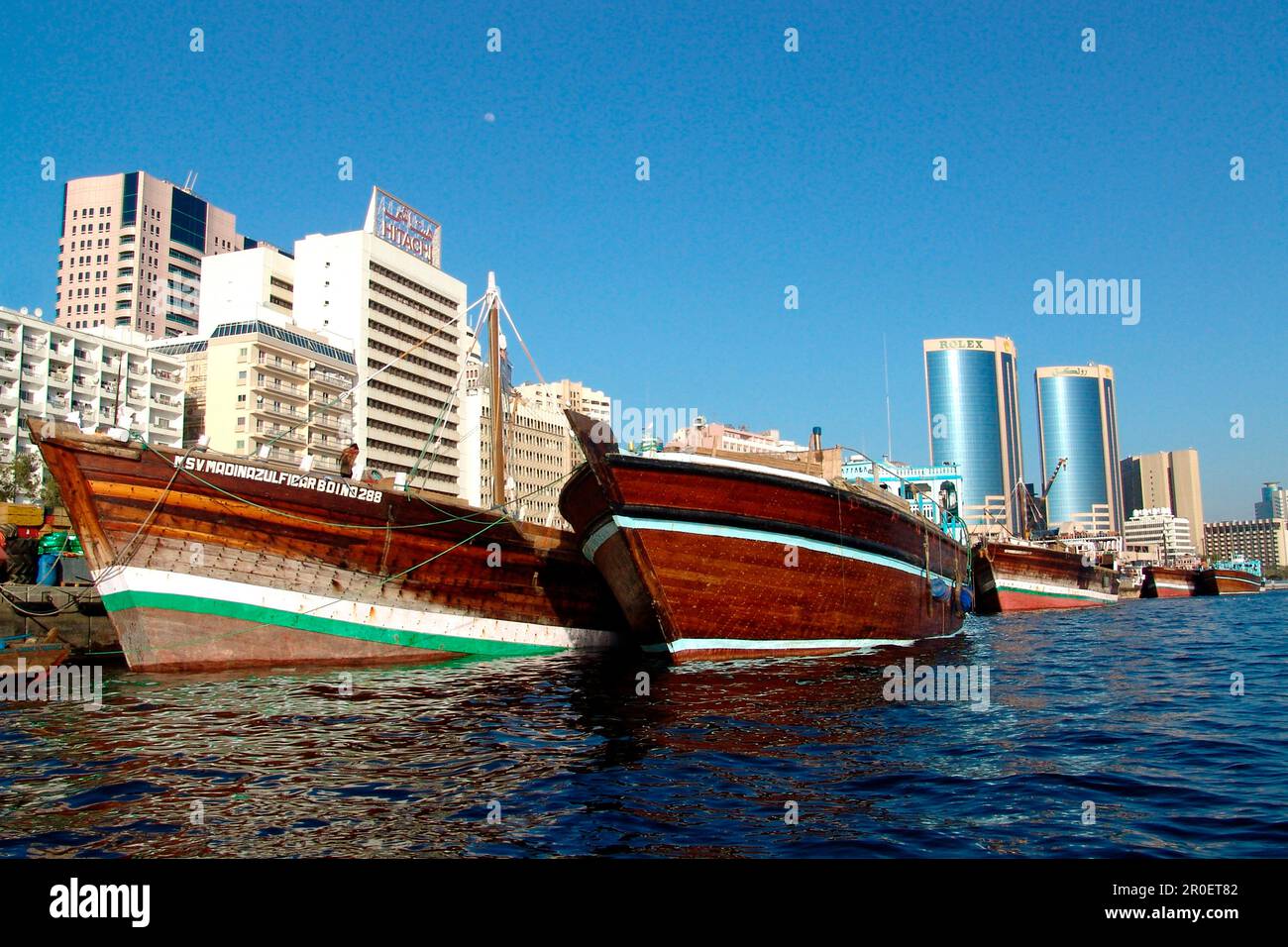 Dhow boats on Dubai Creek in front of modern high rise buildings, Dubai ...