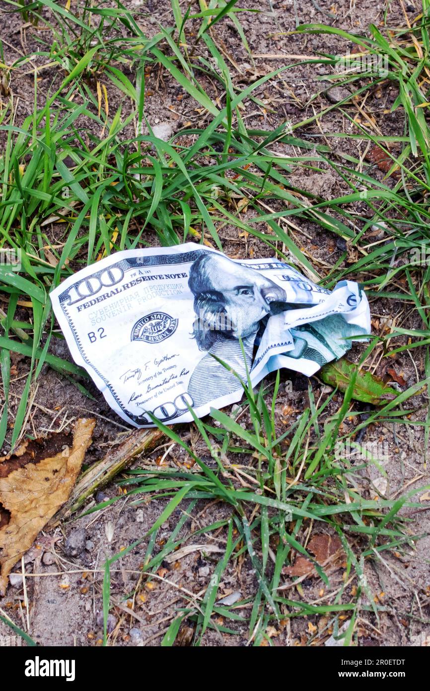 Crumpled one hundred dollar bill on the ground Stock Photo - Alamy