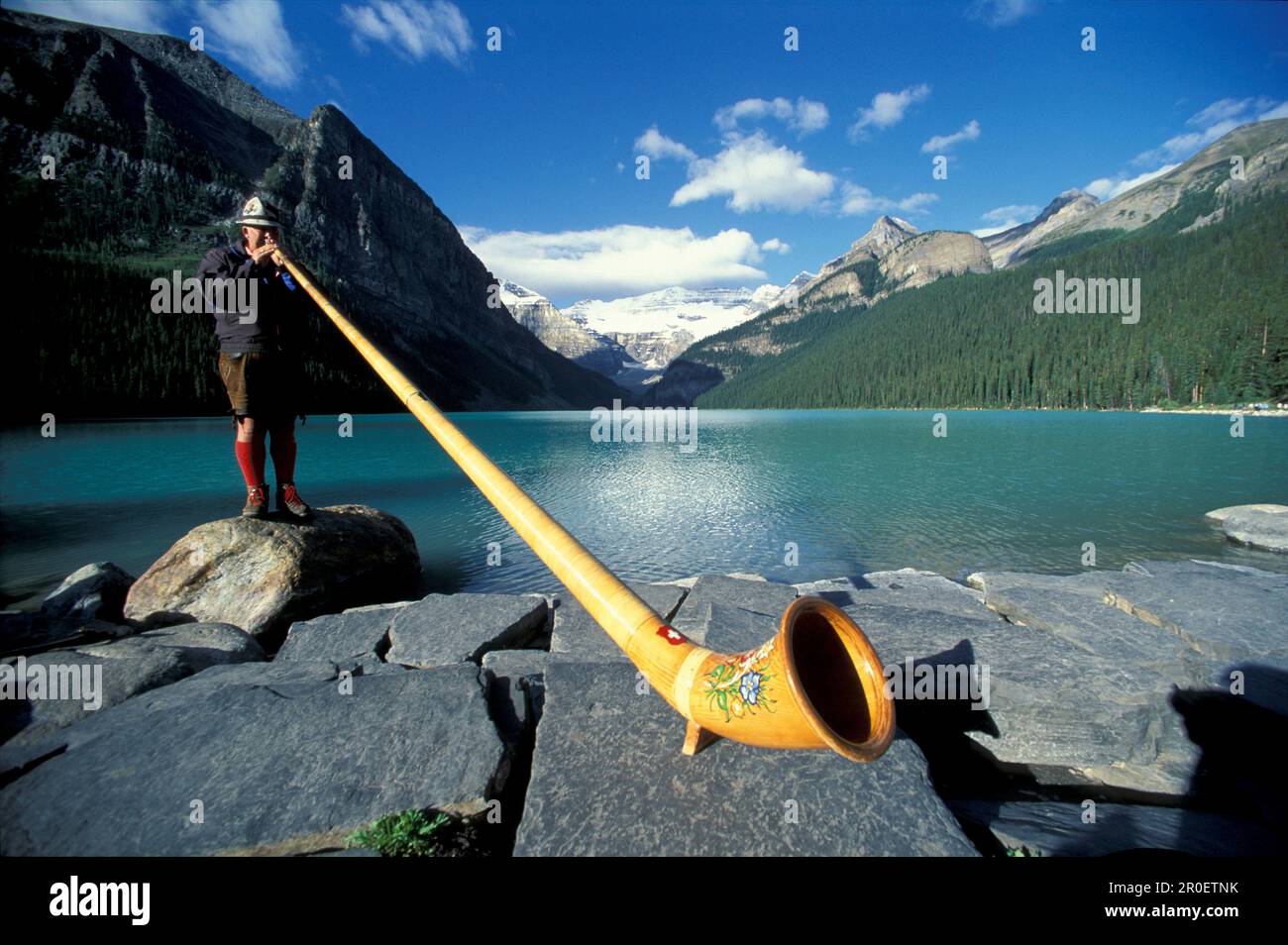 Man blowing an alp horn at Lake Louise, Rocky Mountains, Alberta ...