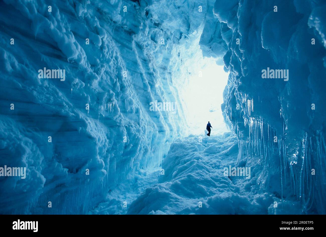 Mountain guide walking through an ice crevice, Am Brokarjoekull, a ...