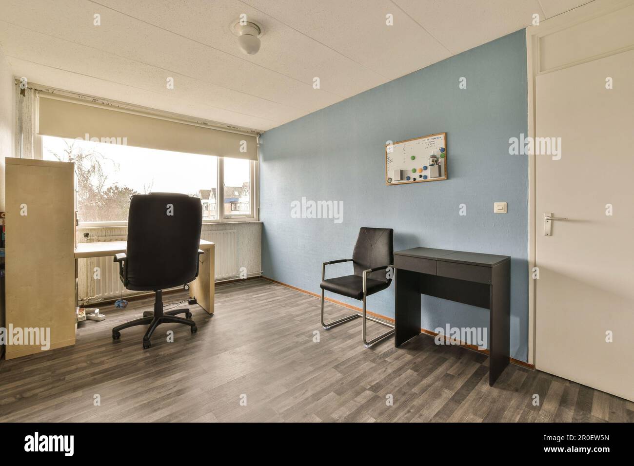 a room with a desk, chair and computer on the floor in front of an open ...