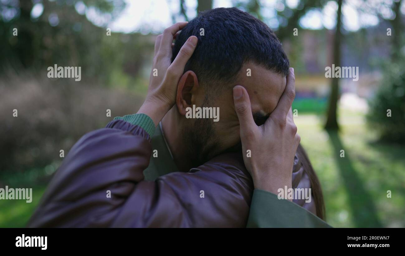Man suffering from grief being consoled by female friend standing ...