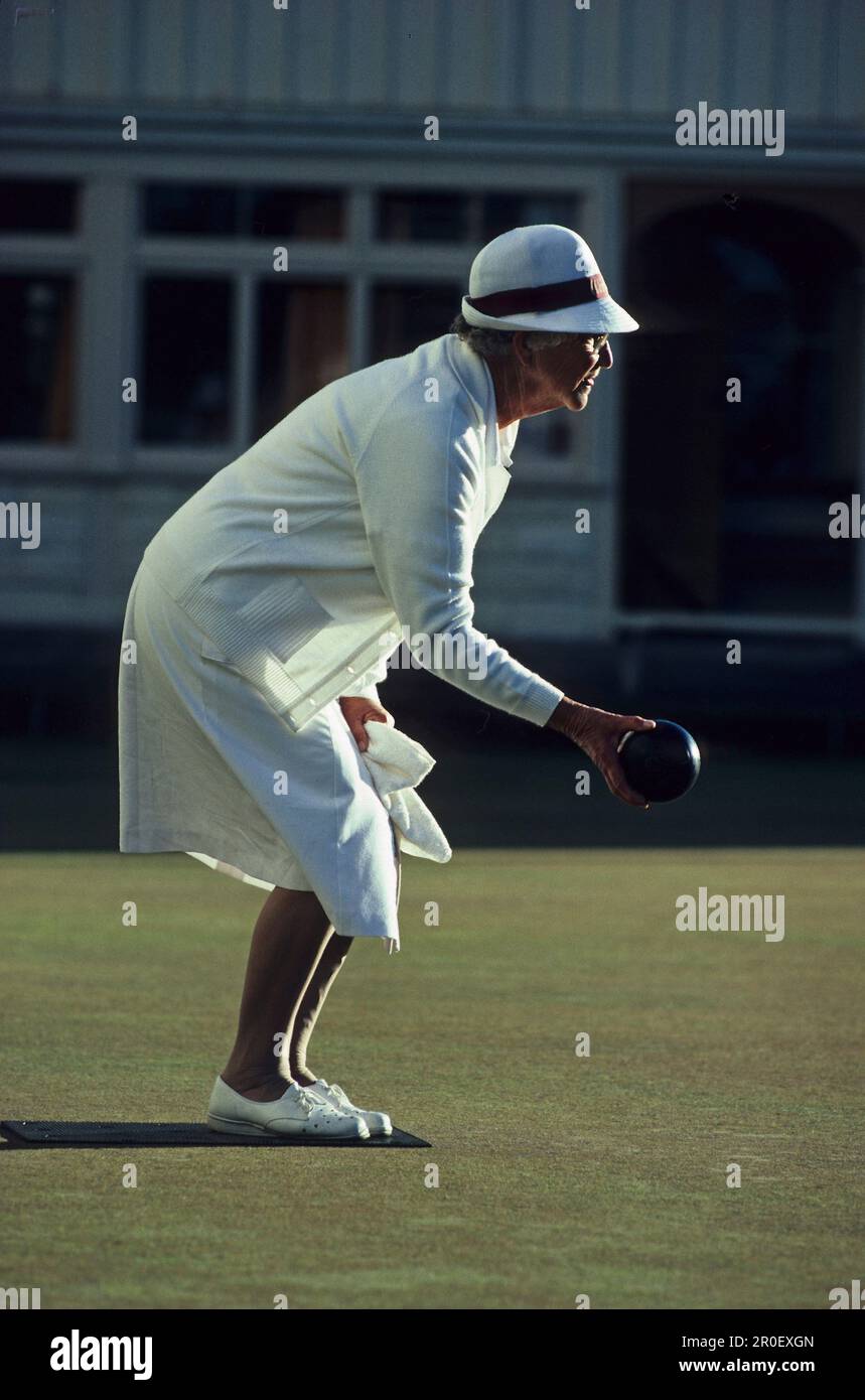 Bowling lady in white uniform, Lawn bowls, popular outdoor sport, in ...