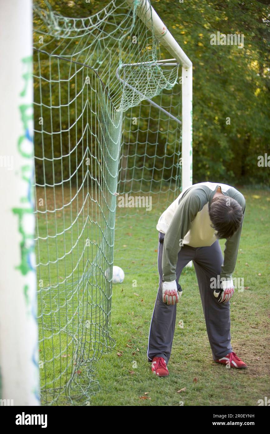 Young goalkeeper is angry about goal against Stock Photo - Alamy