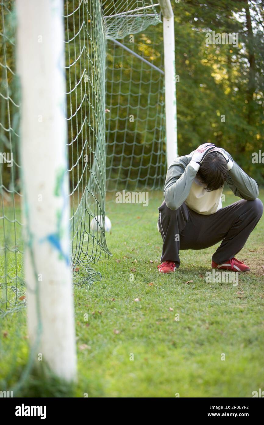 Young goalkeeper is angry about goal against Stock Photo - Alamy