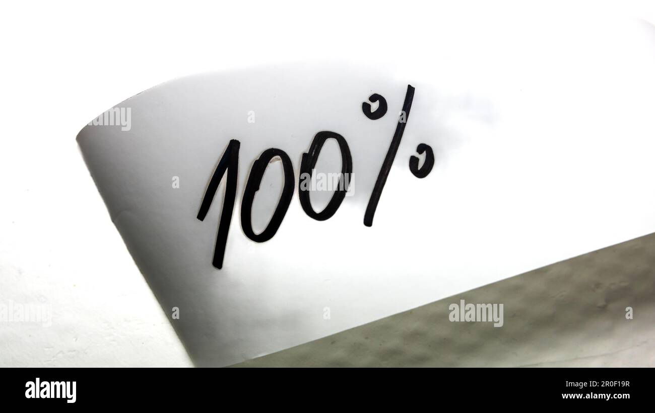 Writing 100 percent on white label on white background Stock Photo - Alamy