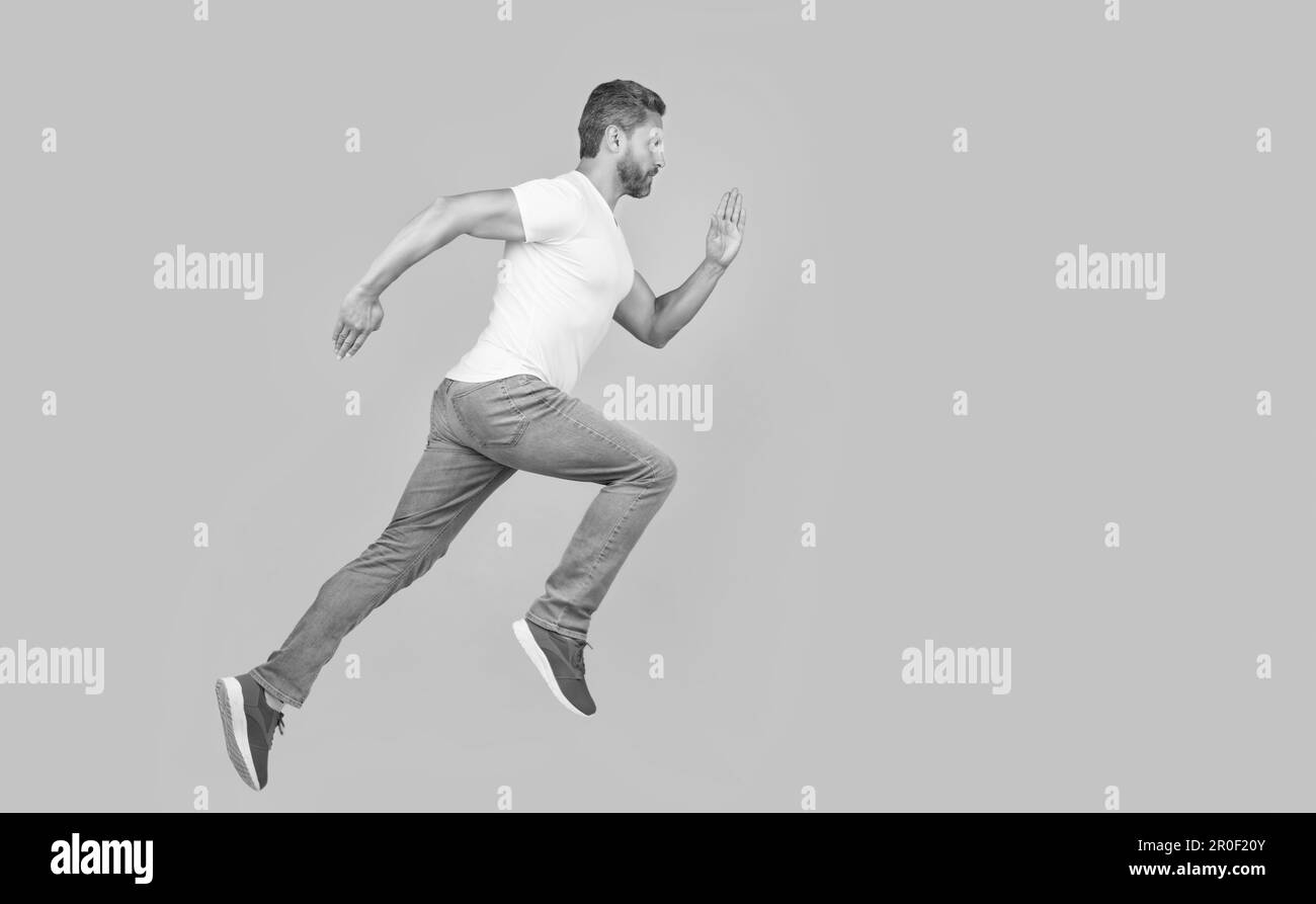 Energetic man running. Guy runner running on studio yellow background ...
